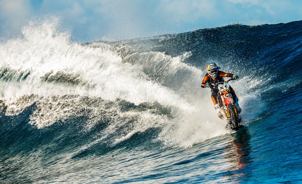 GUY USES MOTORCYCLE TO RIDE WAVES, CHALLENGES REALITY - Action A Go Go, LLC